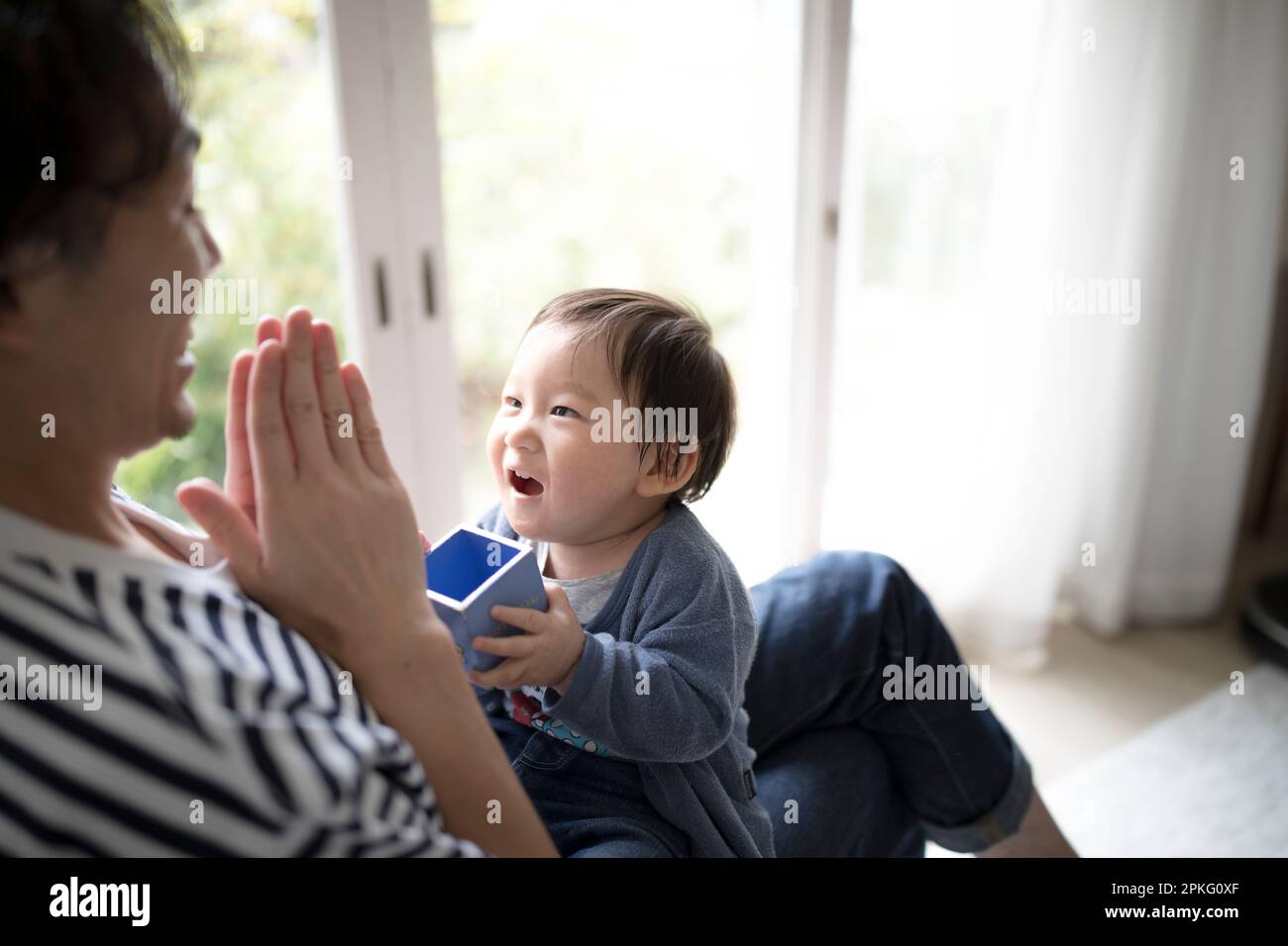 Baby playing with father Stock Photo - Alamy