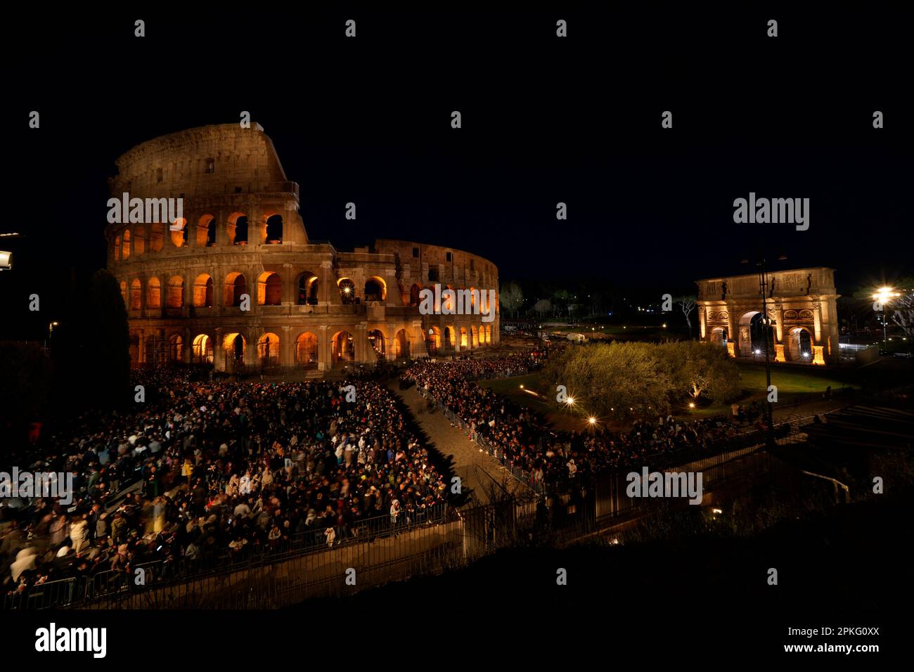 People gather around the Colosseum to attend the Via Crucis (Way of the ...