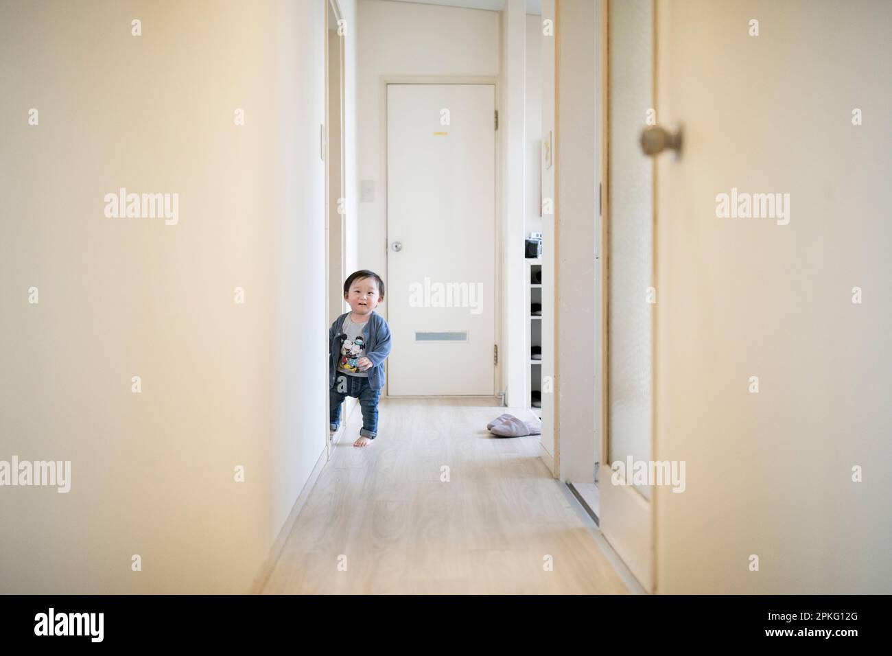 Baby walking down the hallway Stock Photo - Alamy