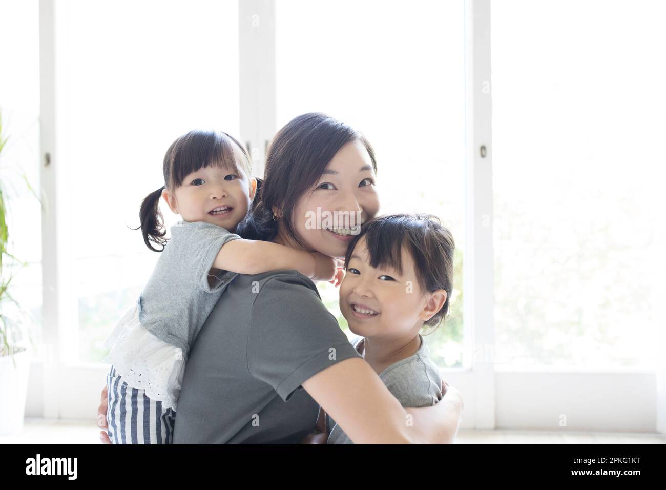 Sisters spoiling their mother Stock Photo - Alamy