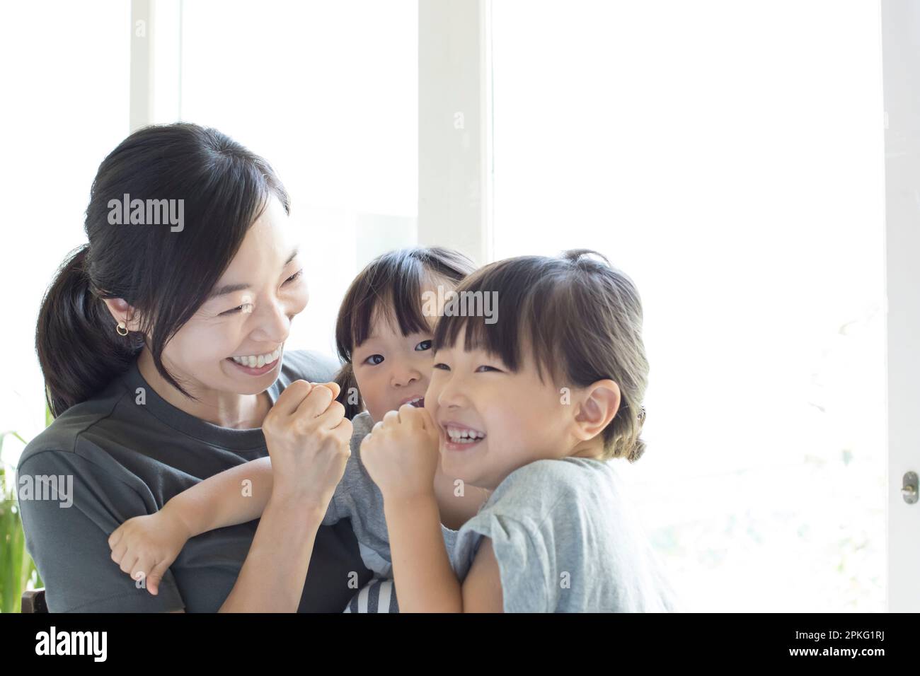 Mother and her two daughters Stock Photo - Alamy