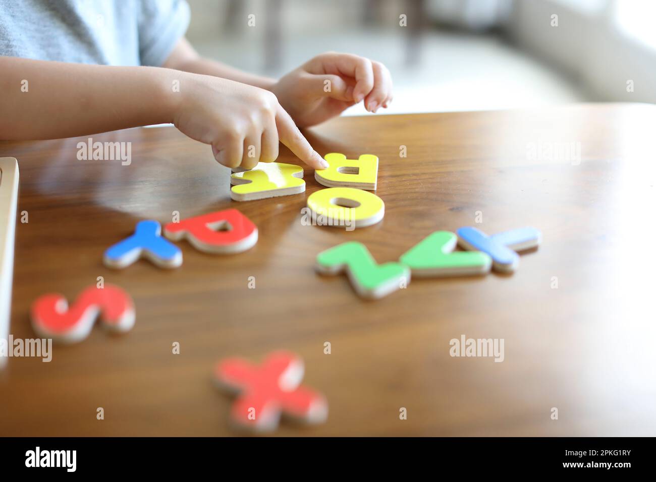 Girl doing alphabet puzzle Stock Photo - Alamy