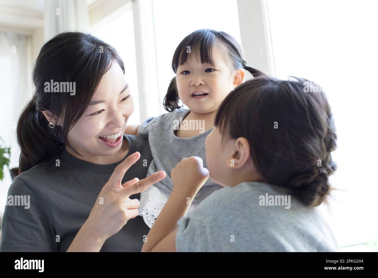 Mother and her two daughters Stock Photo - Alamy
