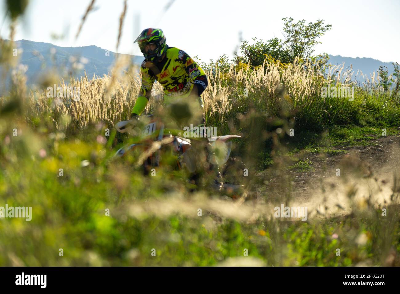 Motorbiker riding his motorbike on the motocross road in nature Stock ...