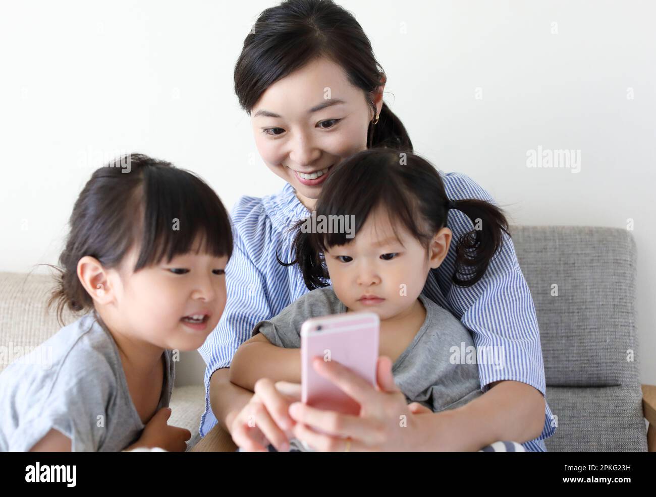 Parent and child looking at a smartphone Stock Photo - Alamy