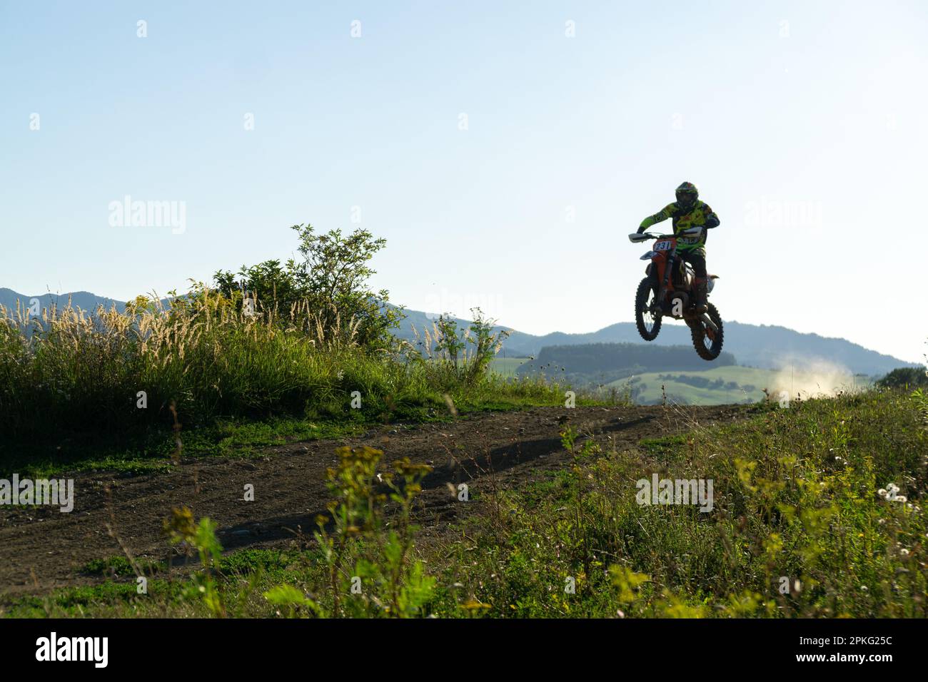 Motorbiker riding his motorbike on the motocross road in nature Stock ...