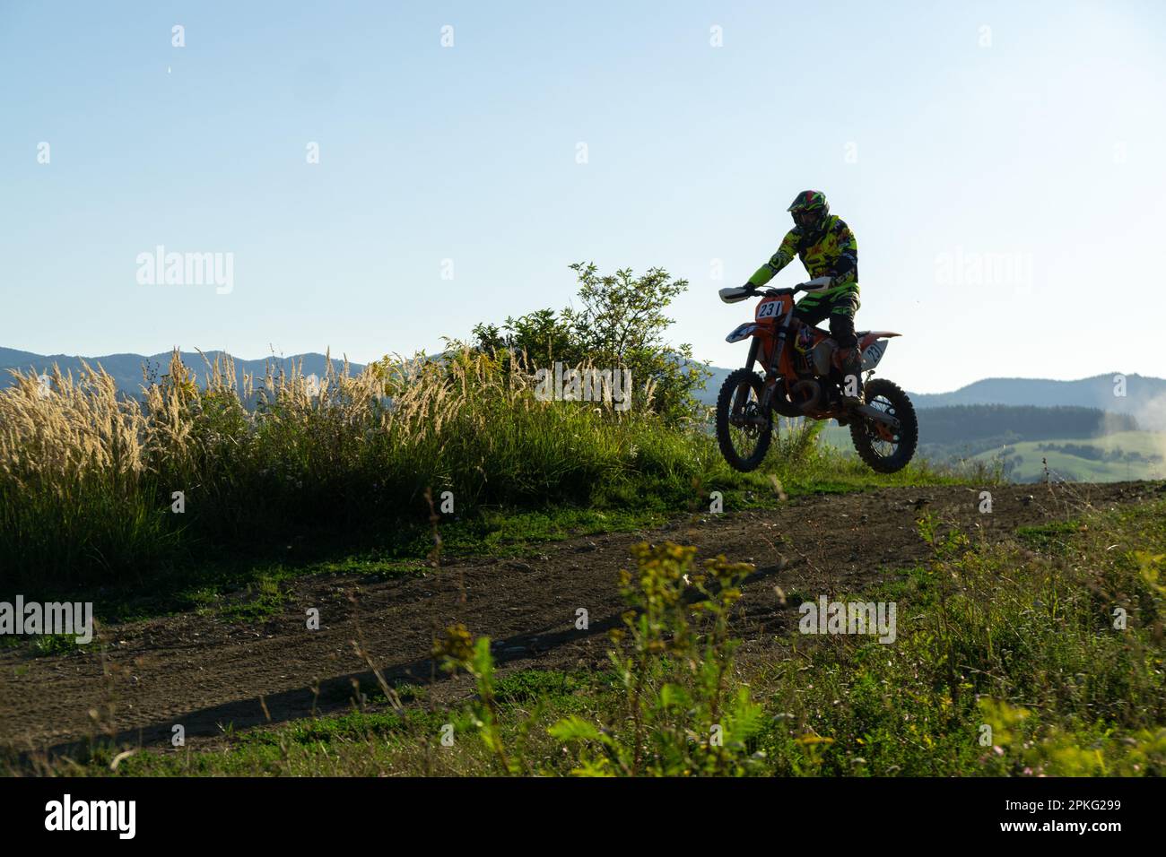 Motorbiker riding his motorbike on the motocross road in nature Stock ...