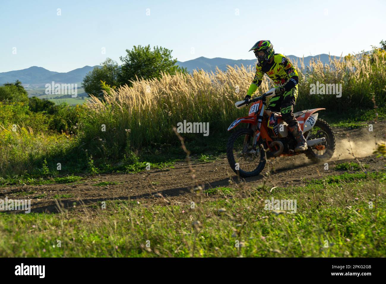 Motorbiker riding his motorbike on the motocross road in nature Stock ...