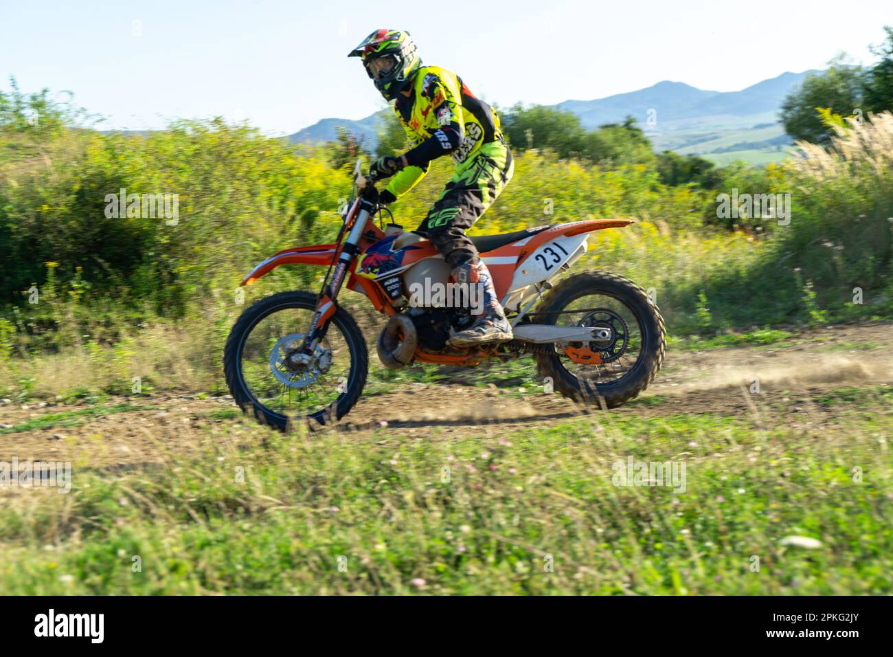 Motorbiker riding his motorbike on the motocross road in nature Stock ...