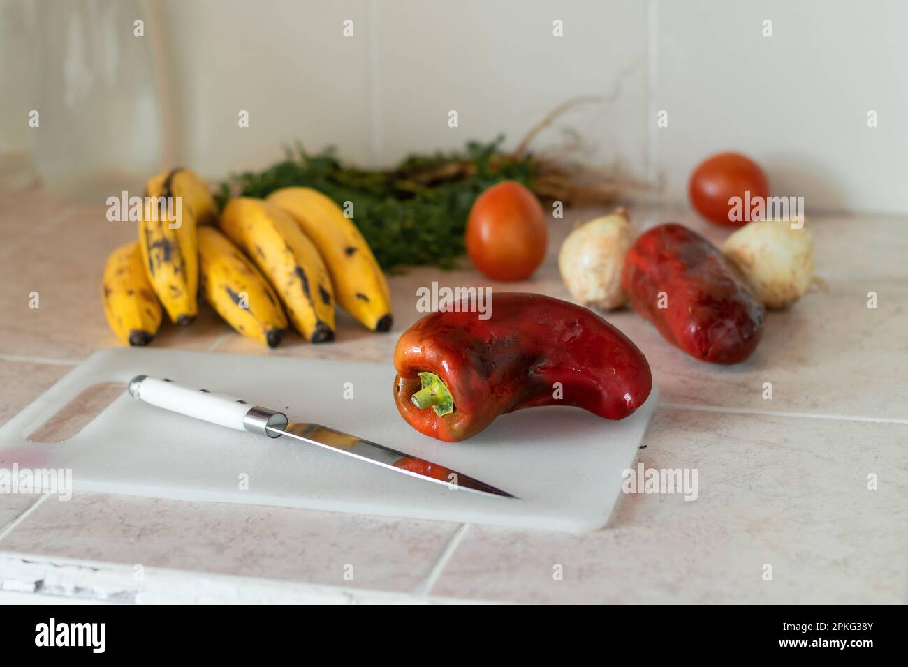 fruits and vegetables on the kitchen counter ready to be cut and ...
