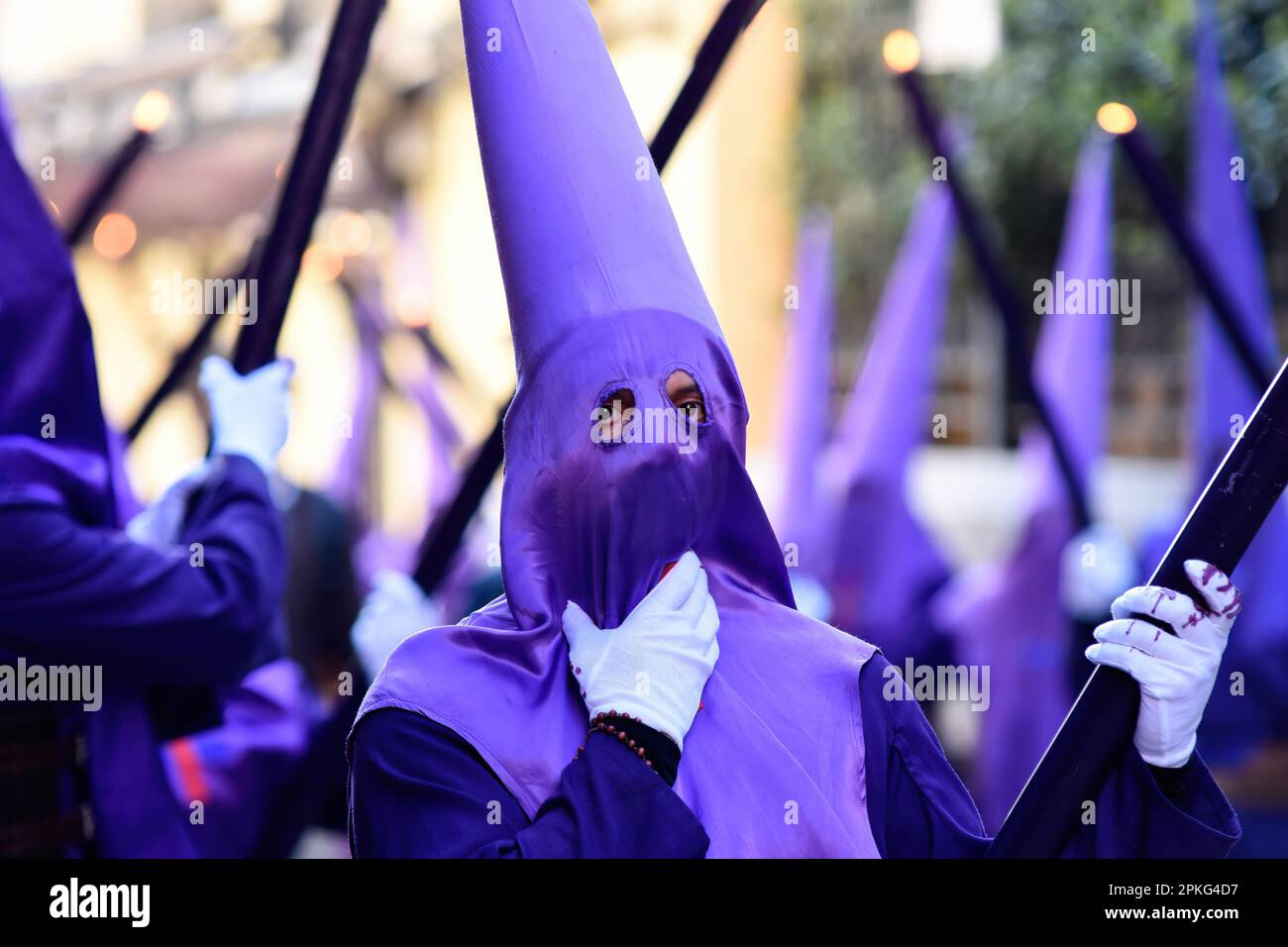 The Nazarenes dressed in purple only reveal their eyes during the Holy ...
