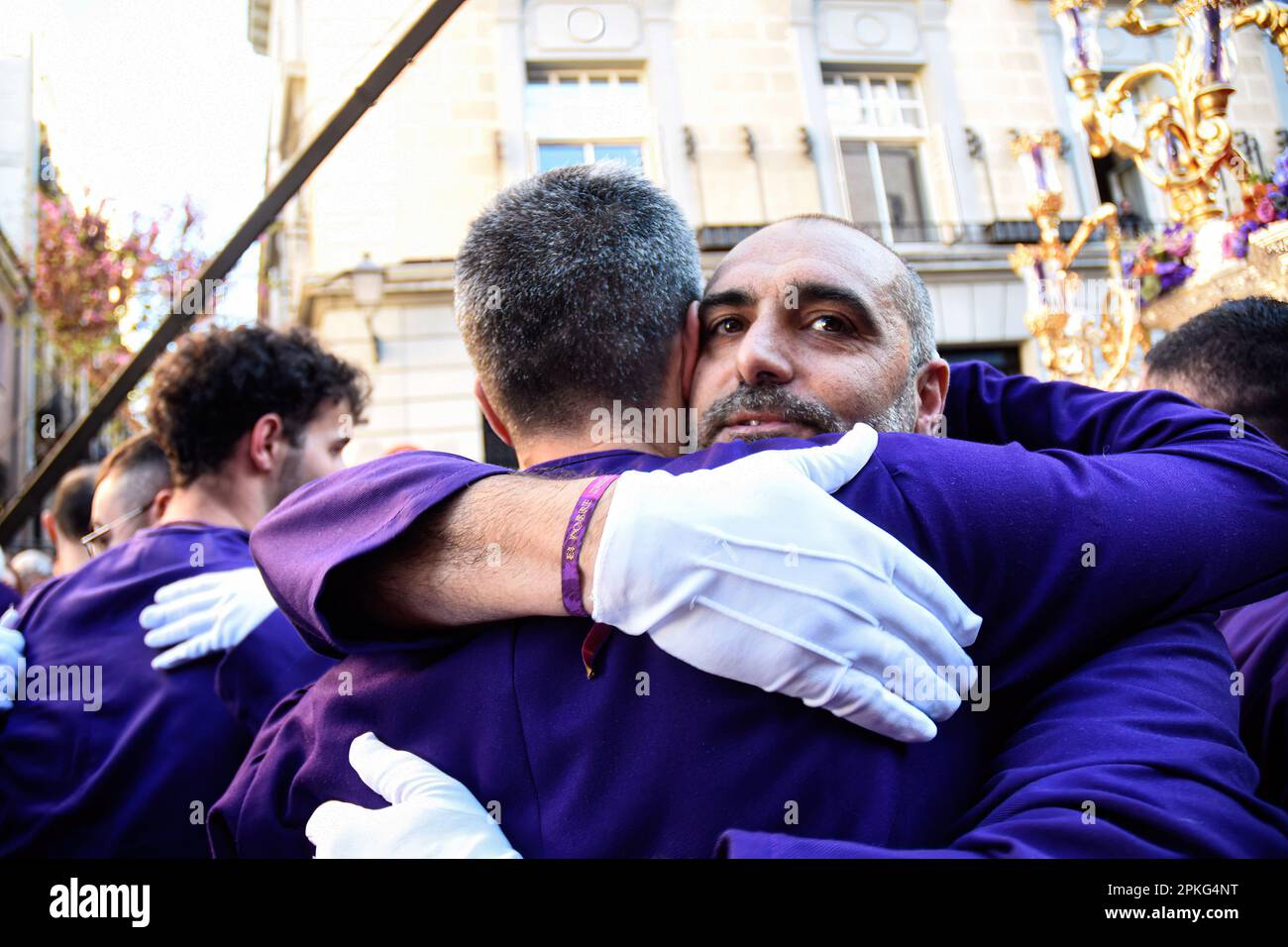 Walkers embrace one another during the Holy Week procession. The ...