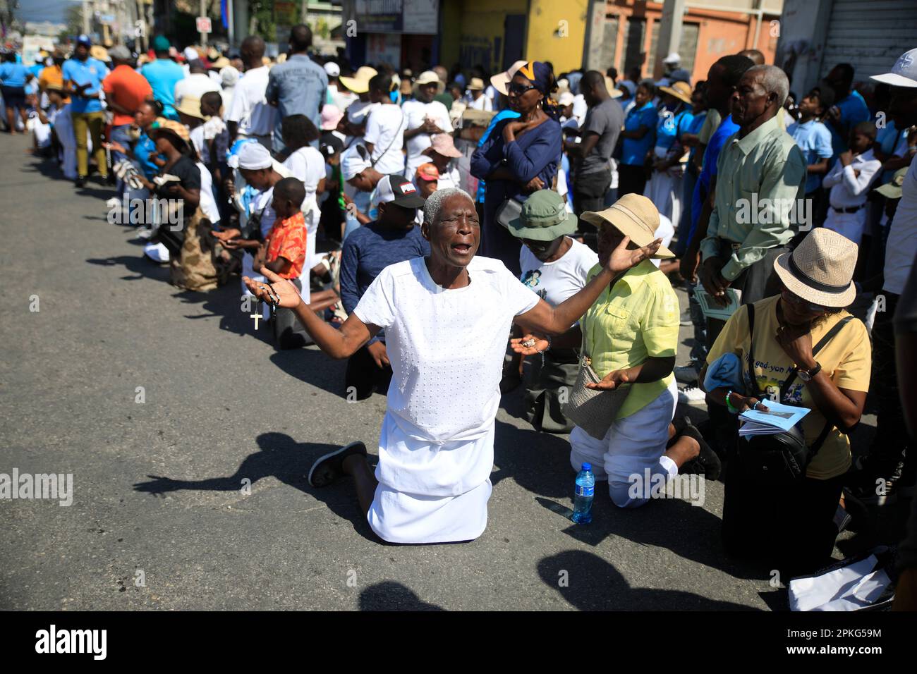 Faithful kneel in prayer during a Good Friday procession in Port-au ...