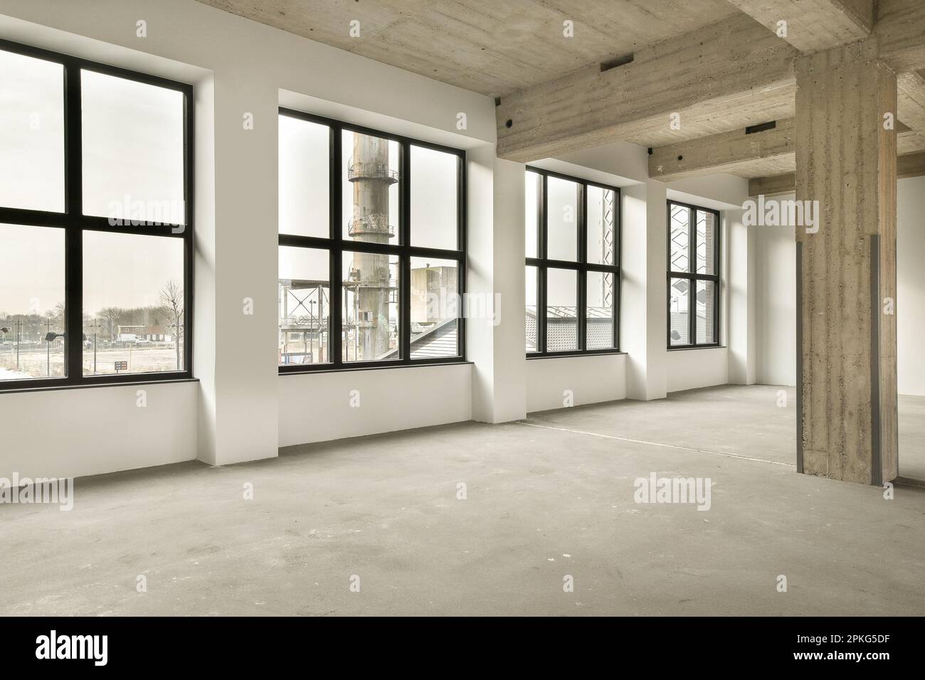 an empty room with large windows and lots of light coming in from the ...