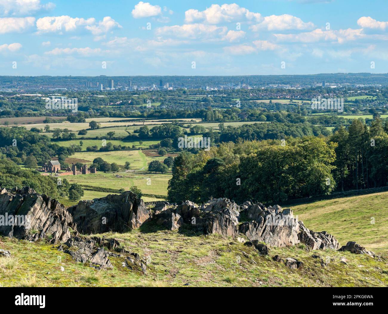 The city of Leicester in the distance as seen from a rocky countryside ...