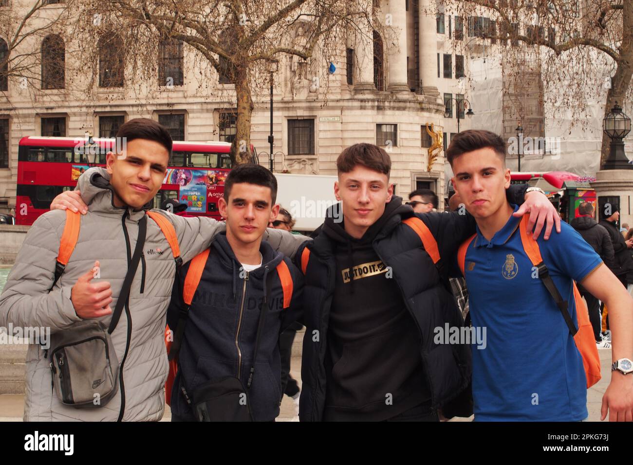 Four young men, teenagers, from Portugal, visiting Trafalgar Square ...