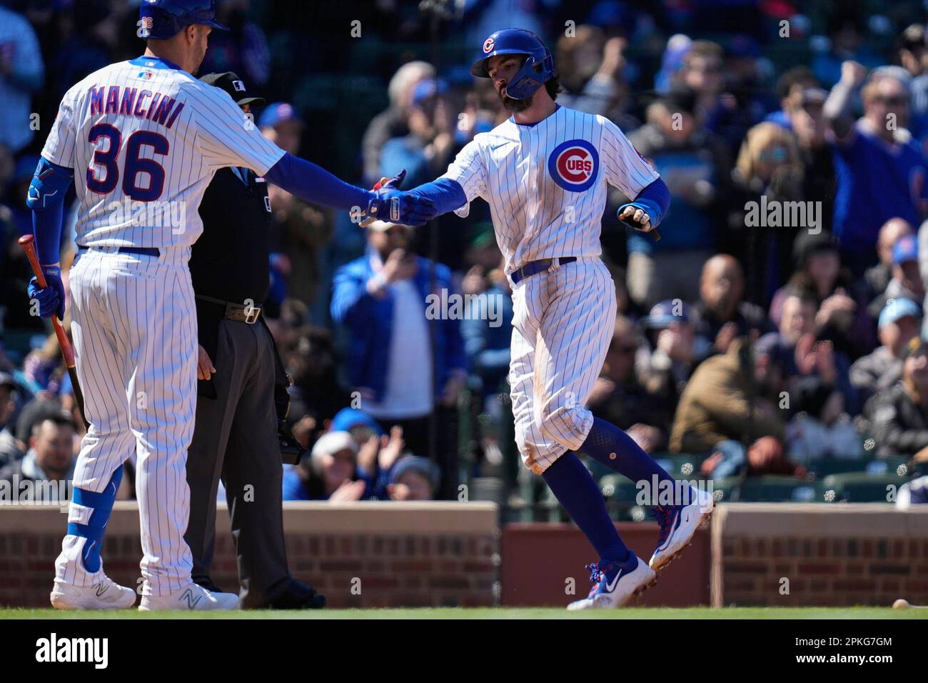 Chicago Cubs shortstop Dansby Swanson slaps hands with Chicago Cubs ...