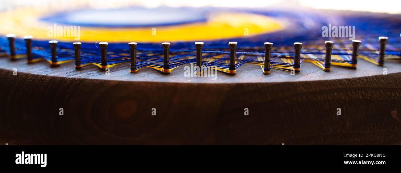 Colored thread mandala on a wooden board with nails. Mandala Moon ...