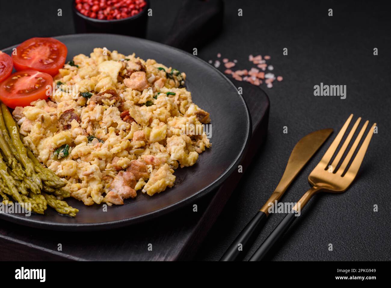 Delicious scramble with salmon, sun-dried tomatoes, spinach, spices and ...