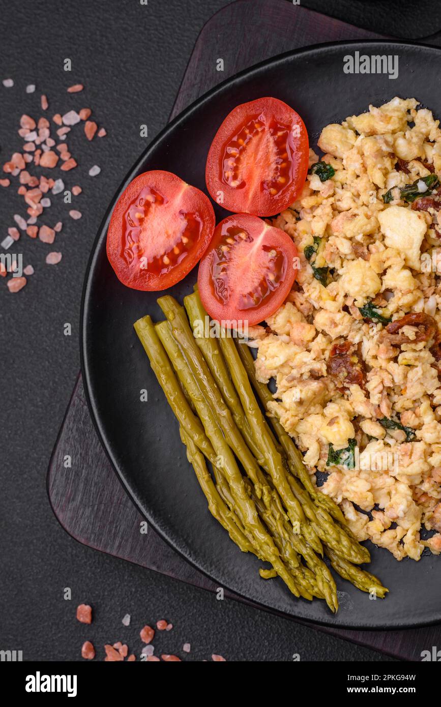 Delicious scramble with salmon, sun-dried tomatoes, spinach, spices and ...