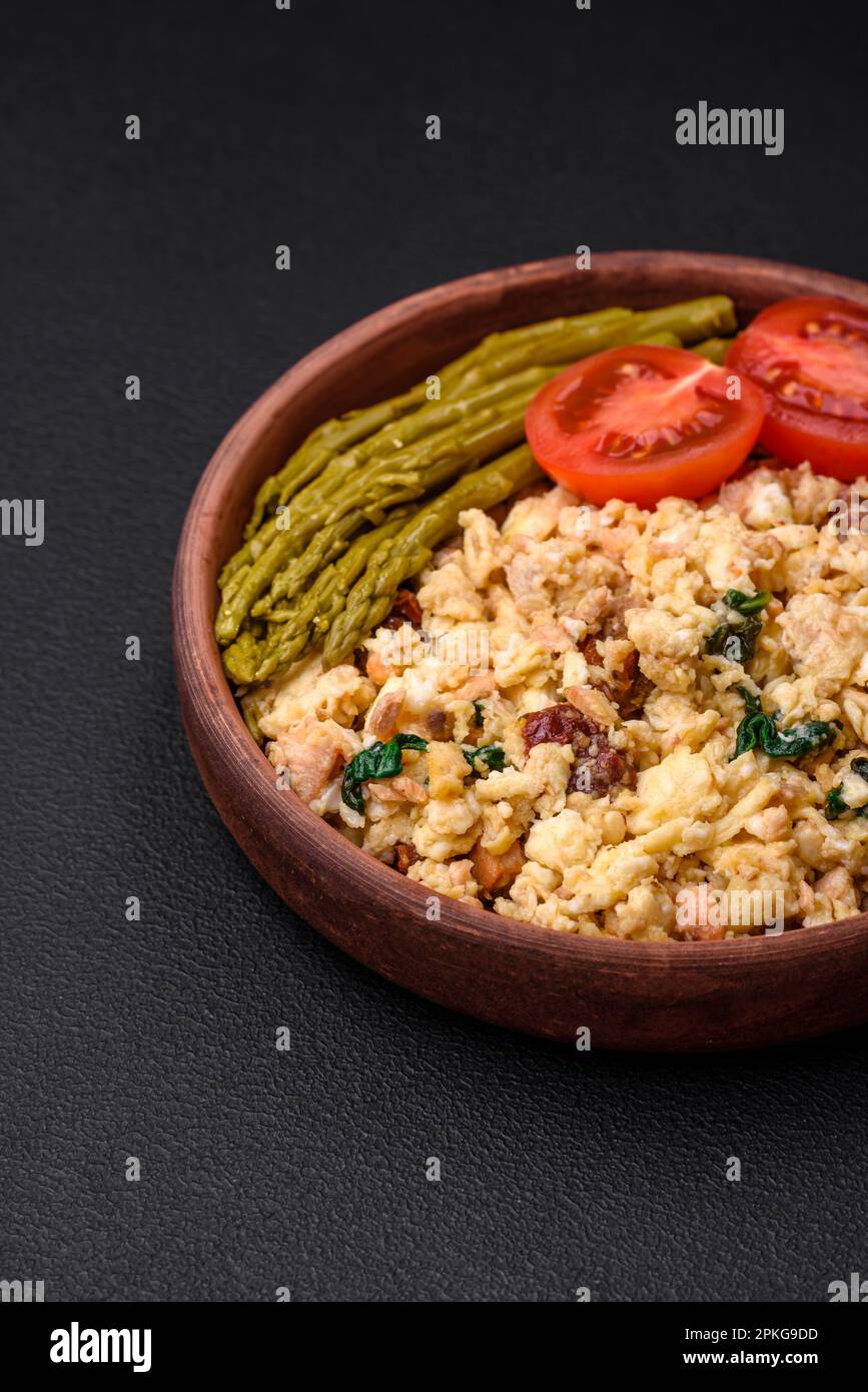 Delicious scramble with salmon, sun-dried tomatoes, spinach, spices and ...