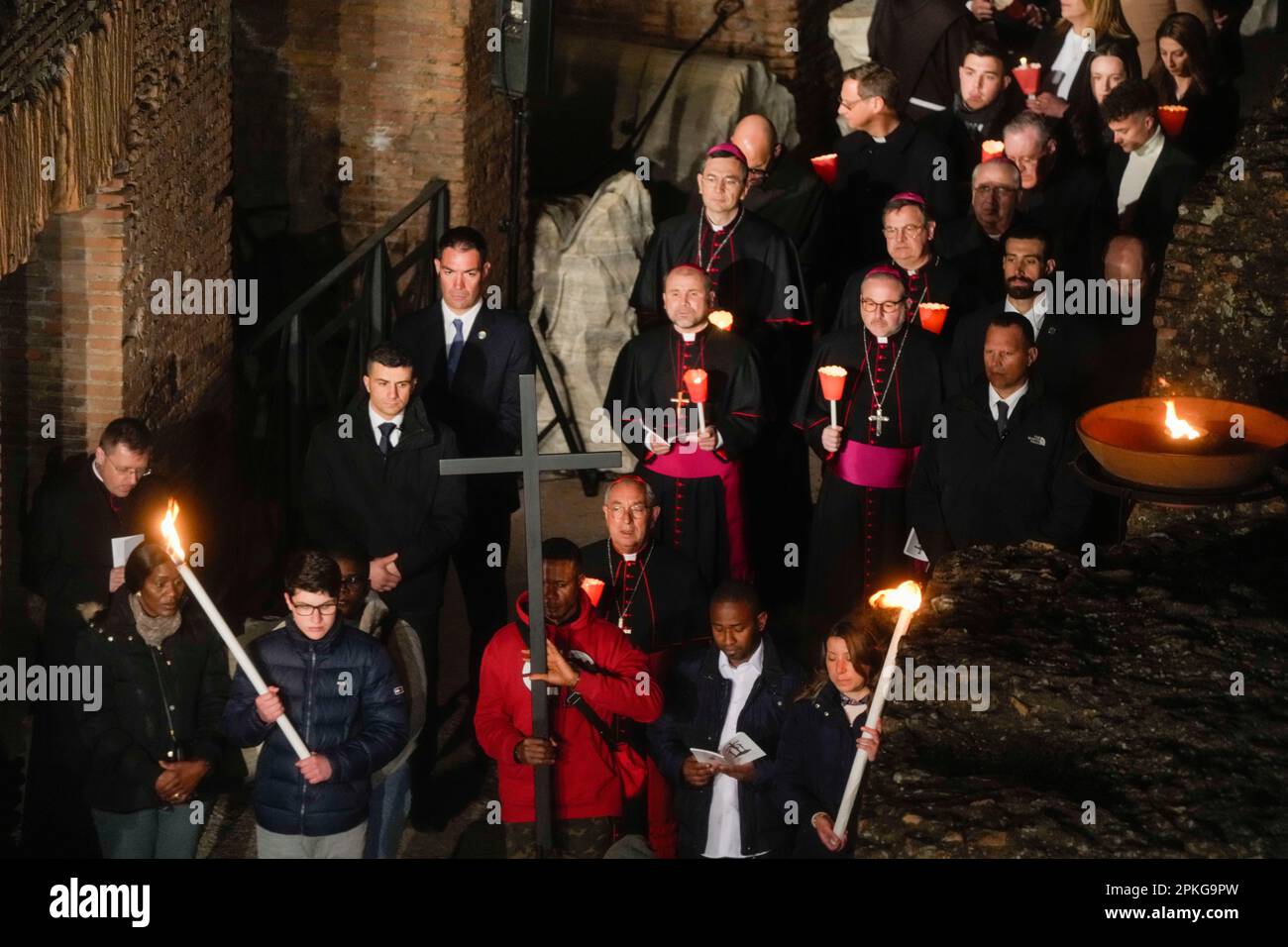 Faithful hold the cross as they take part in the Via Crucis (Way of the ...