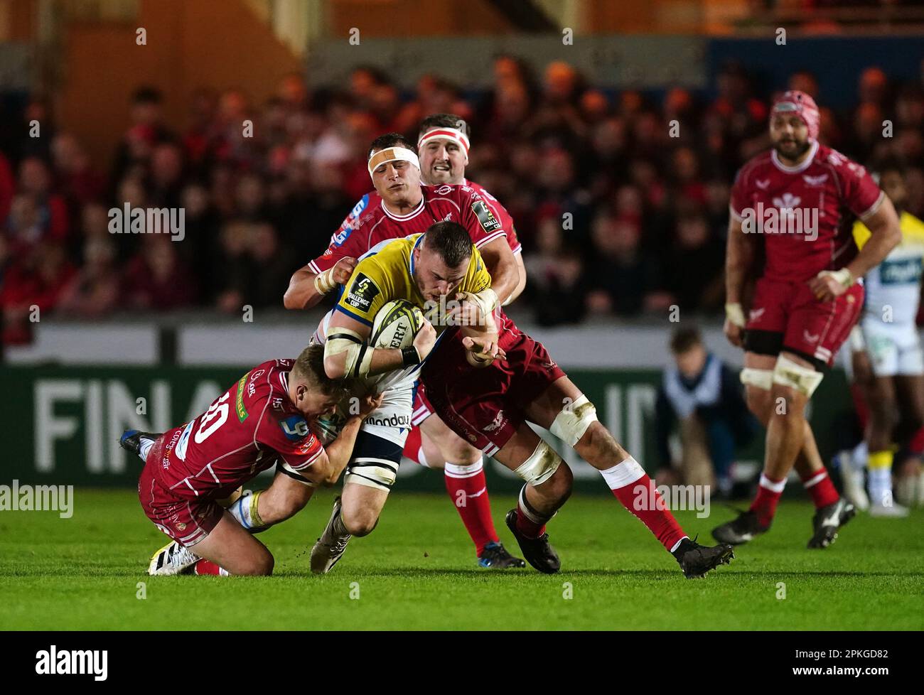 ASM Clermont's Paul Jedrasiak tackled by Scarlets' Aaron Shingler and ...