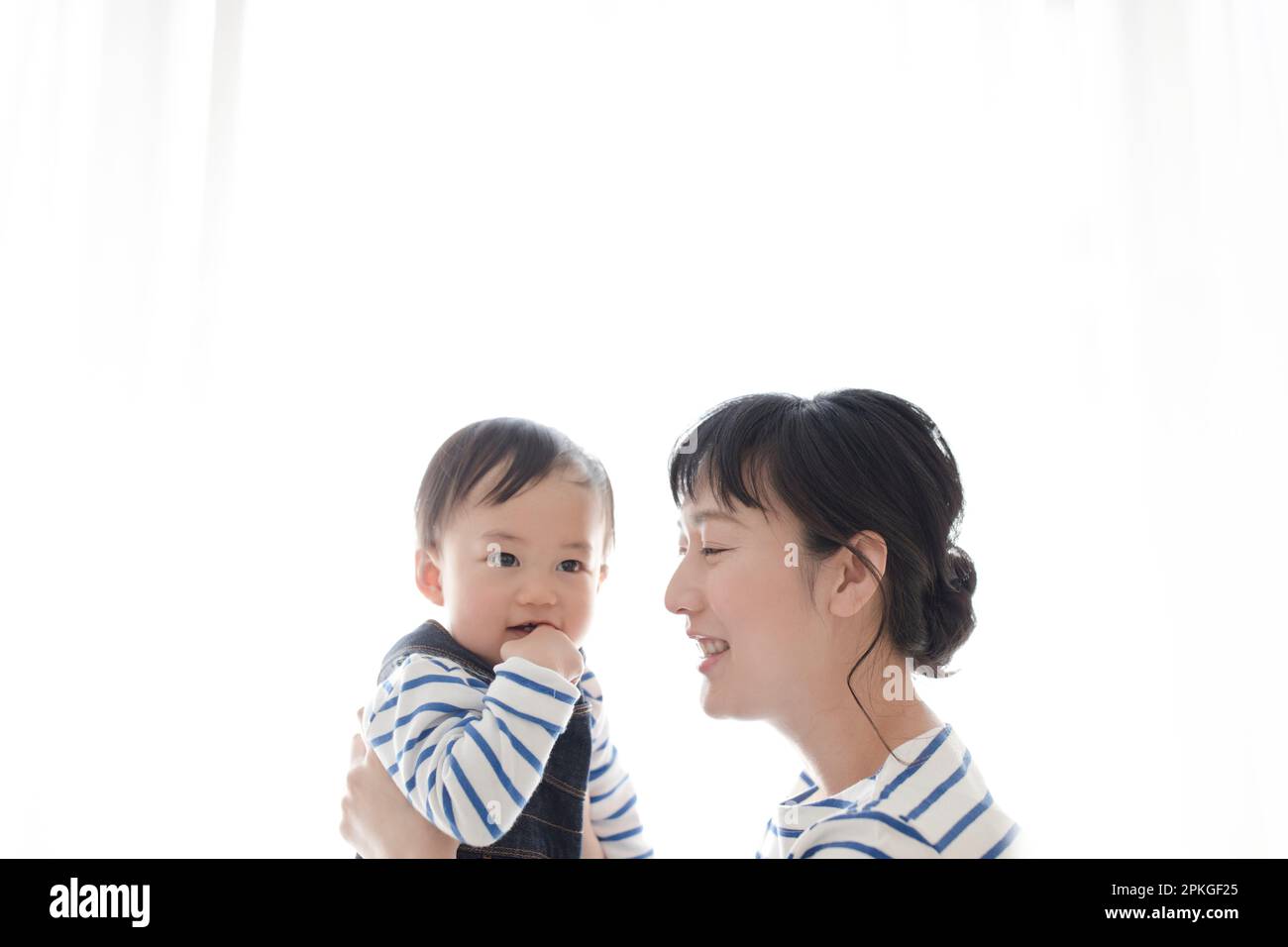 Baby being carried by mother Stock Photo - Alamy