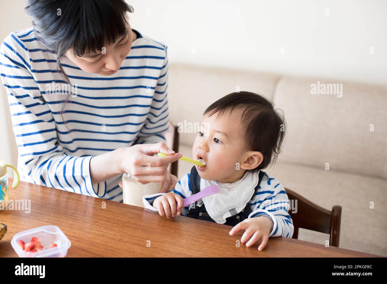 Baby being fed baby food by mother Stock Photo - Alamy
