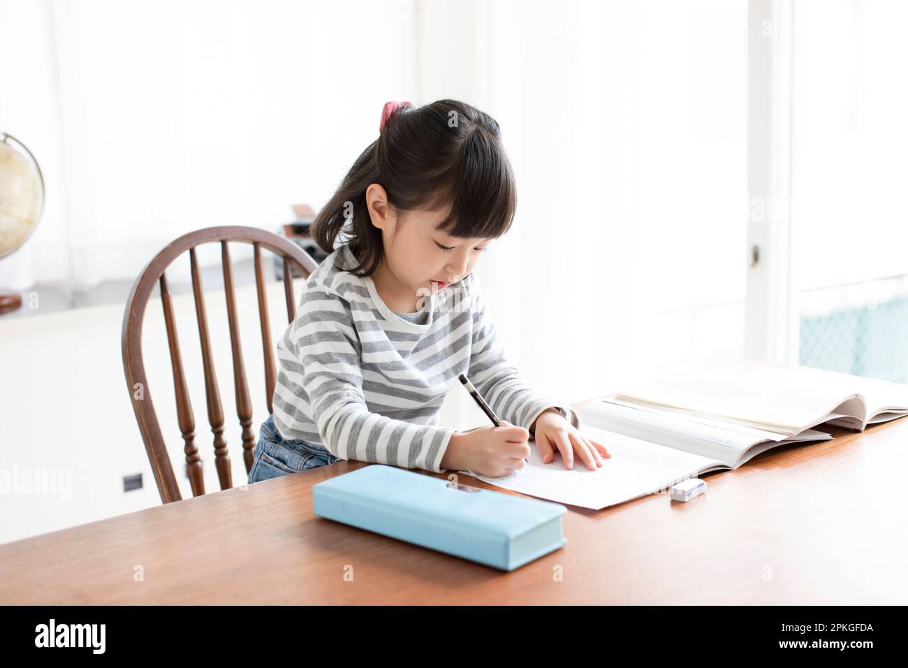 Girl studying in living room Stock Photo - Alamy