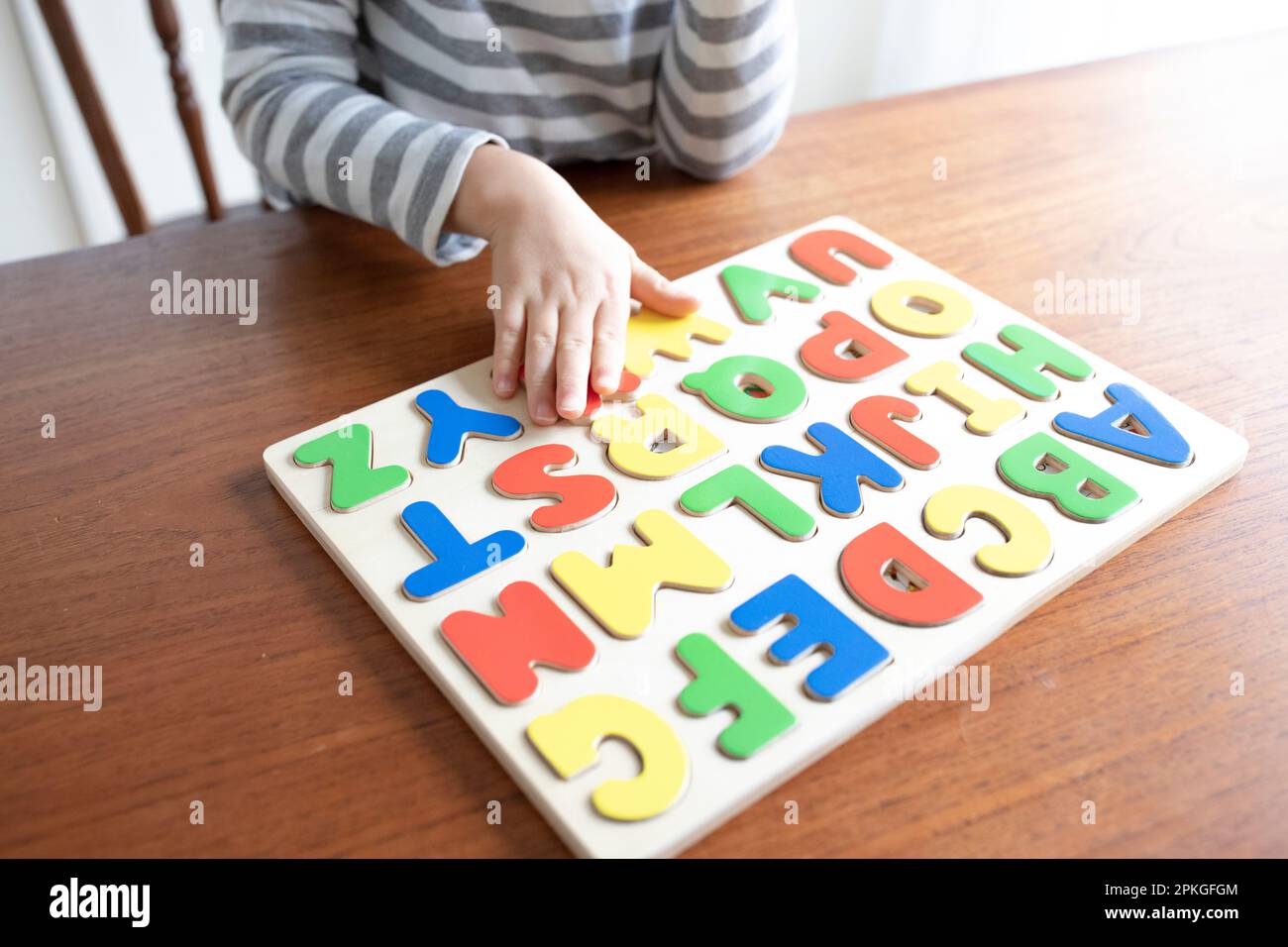 Girl doing english puzzle Stock Photo - Alamy