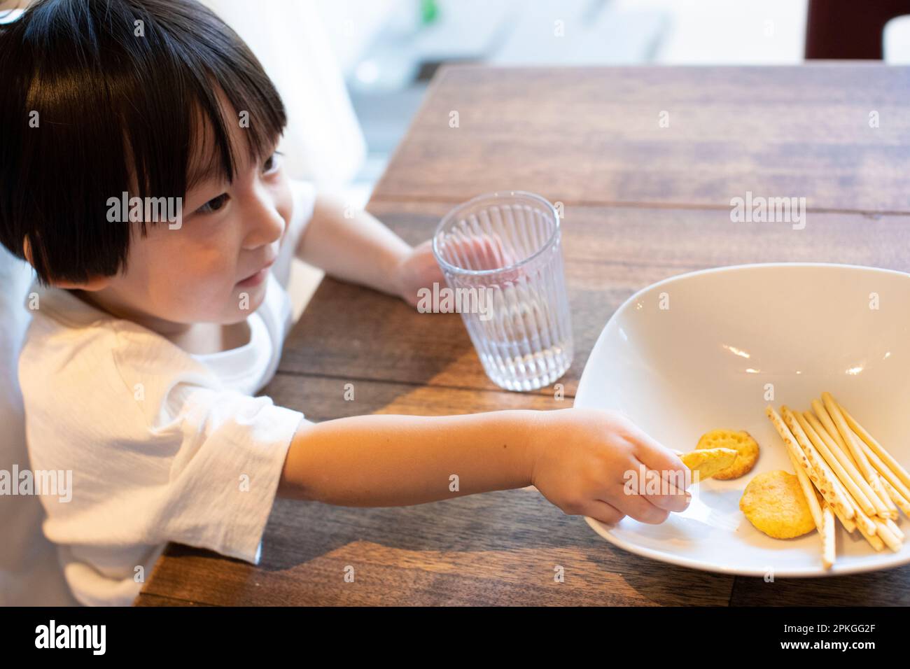 Boy eating a snack Stock Photo - Alamy