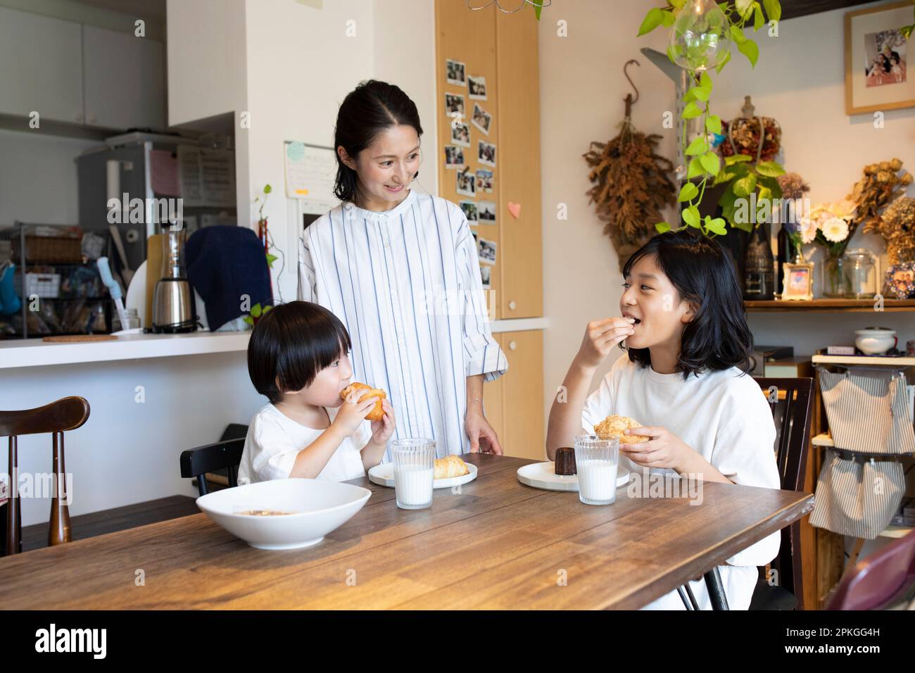 Children eating snacks and their mothers watching them Stock Photo - Alamy