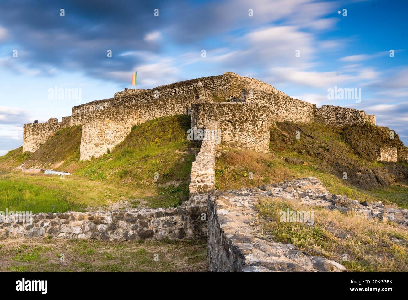 A majestic landscape featuring the ruins of an ancient castle perched ...