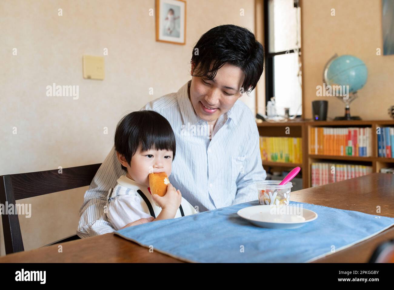 Father with child eating bread Stock Photo - Alamy