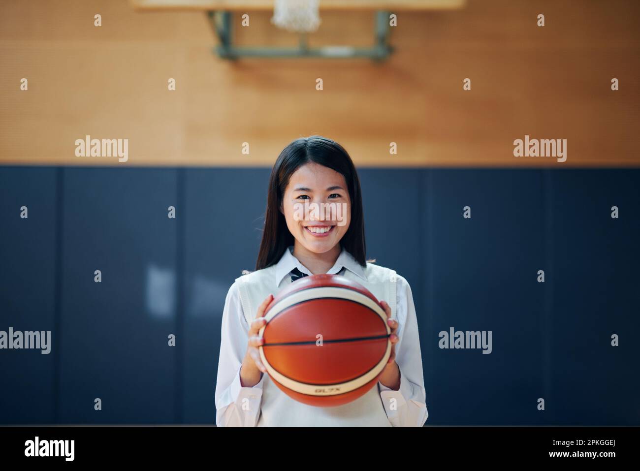 High school girl with basketball in gym Stock Photo - Alamy