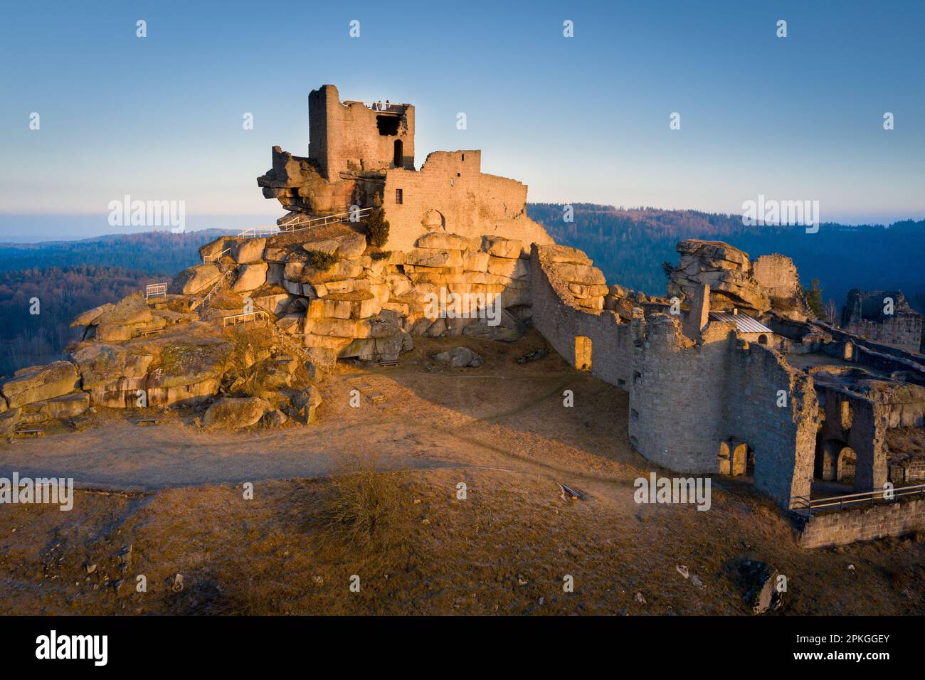 An ancient castle stands atop a rocky outcropping, with majestic ...