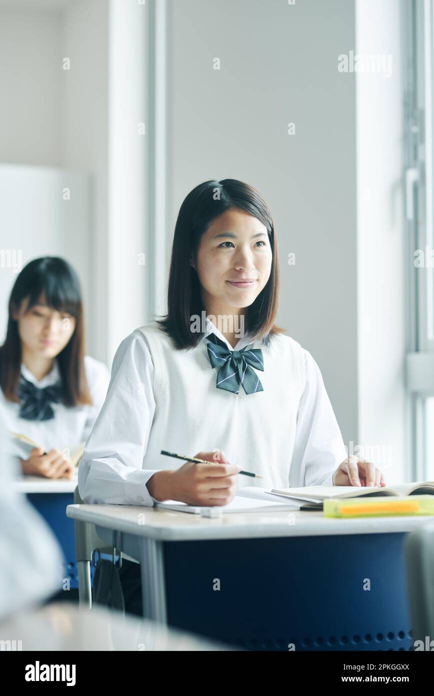 A high school girl taking a class in a classroom Stock Photo - Alamy