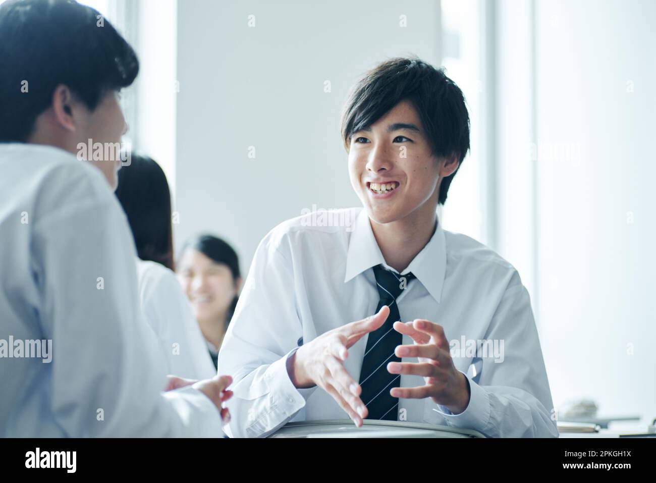 A high school boy chatting in a classroom Stock Photo - Alamy