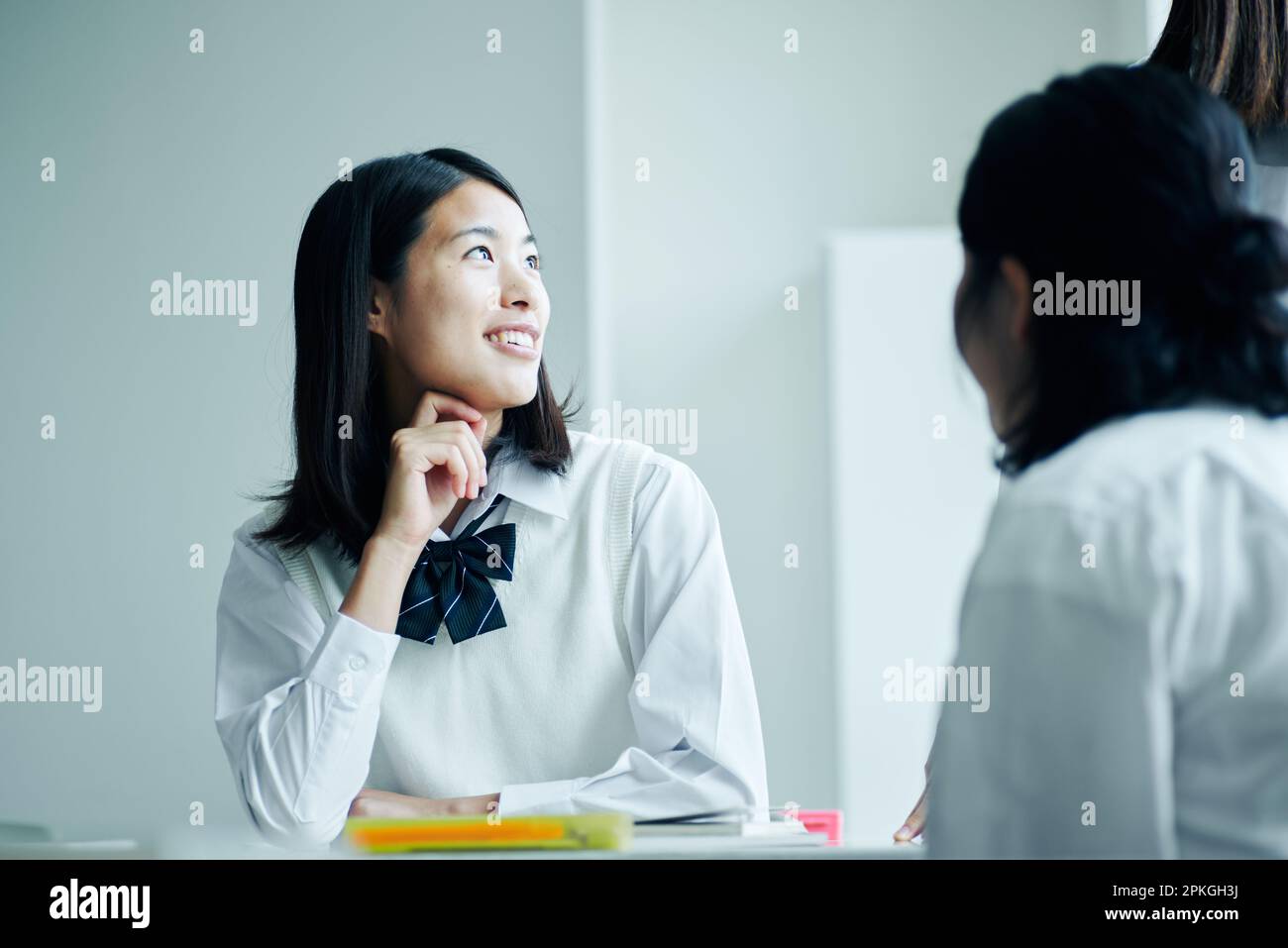 Female high school student chatting in a classroom Stock Photo - Alamy