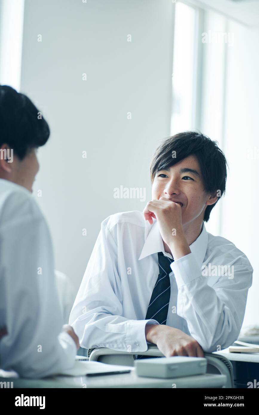 Female high school student chatting in a classroom Stock Photo - Alamy