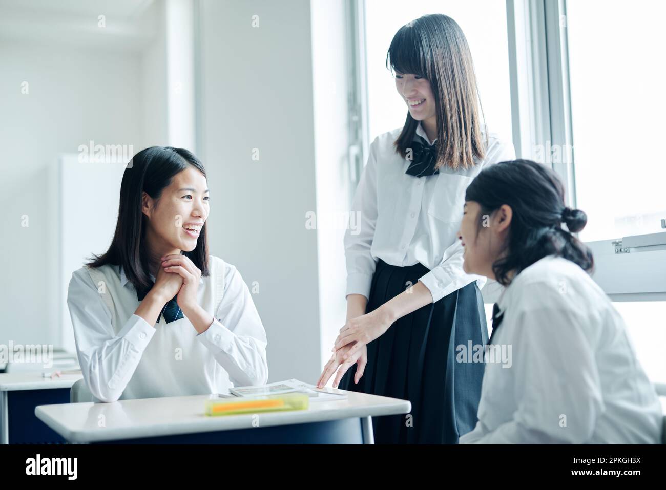 Female high school student chatting in class Stock Photo - Alamy