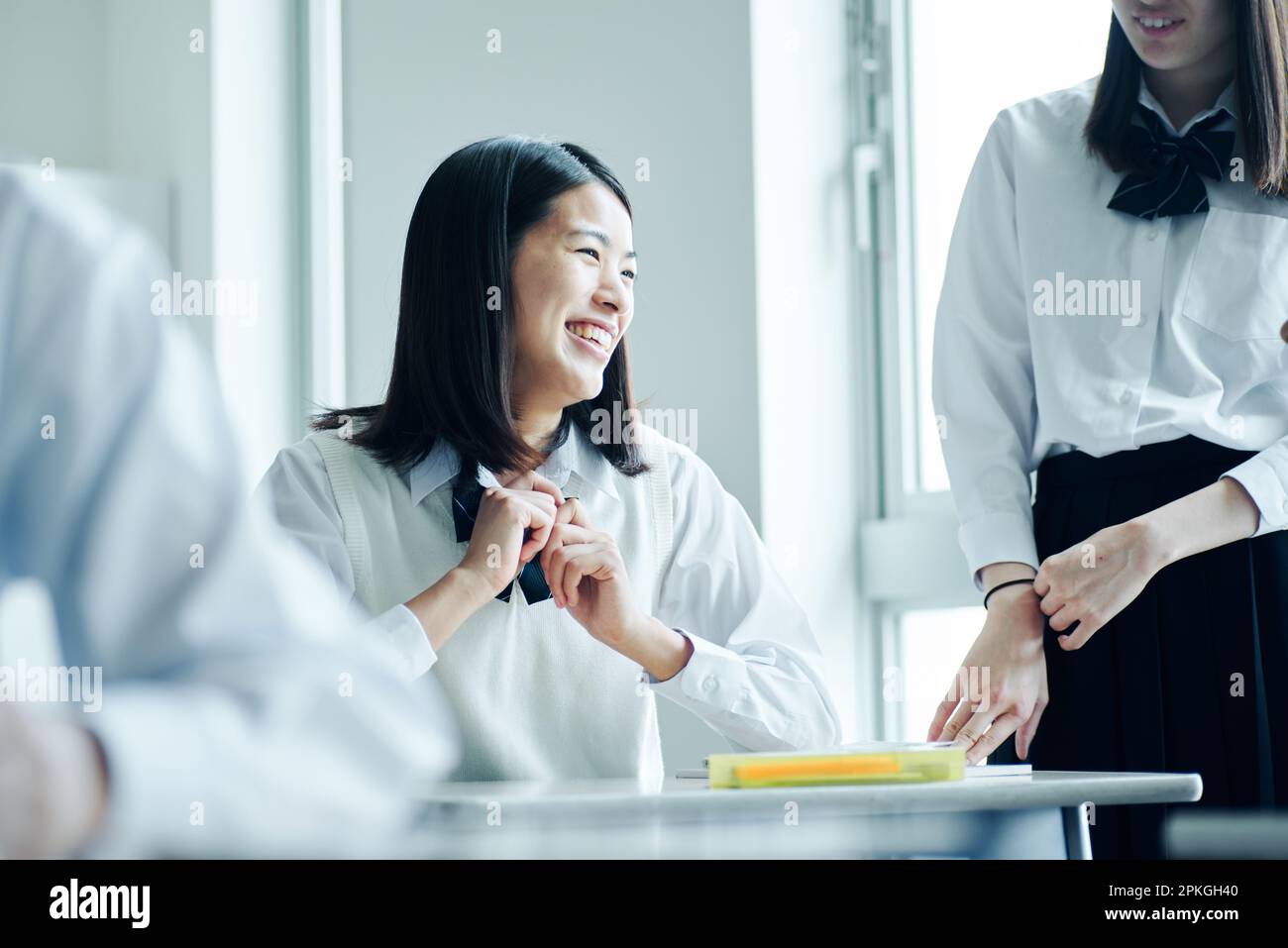 Female high school student chatting in a classroom Stock Photo - Alamy