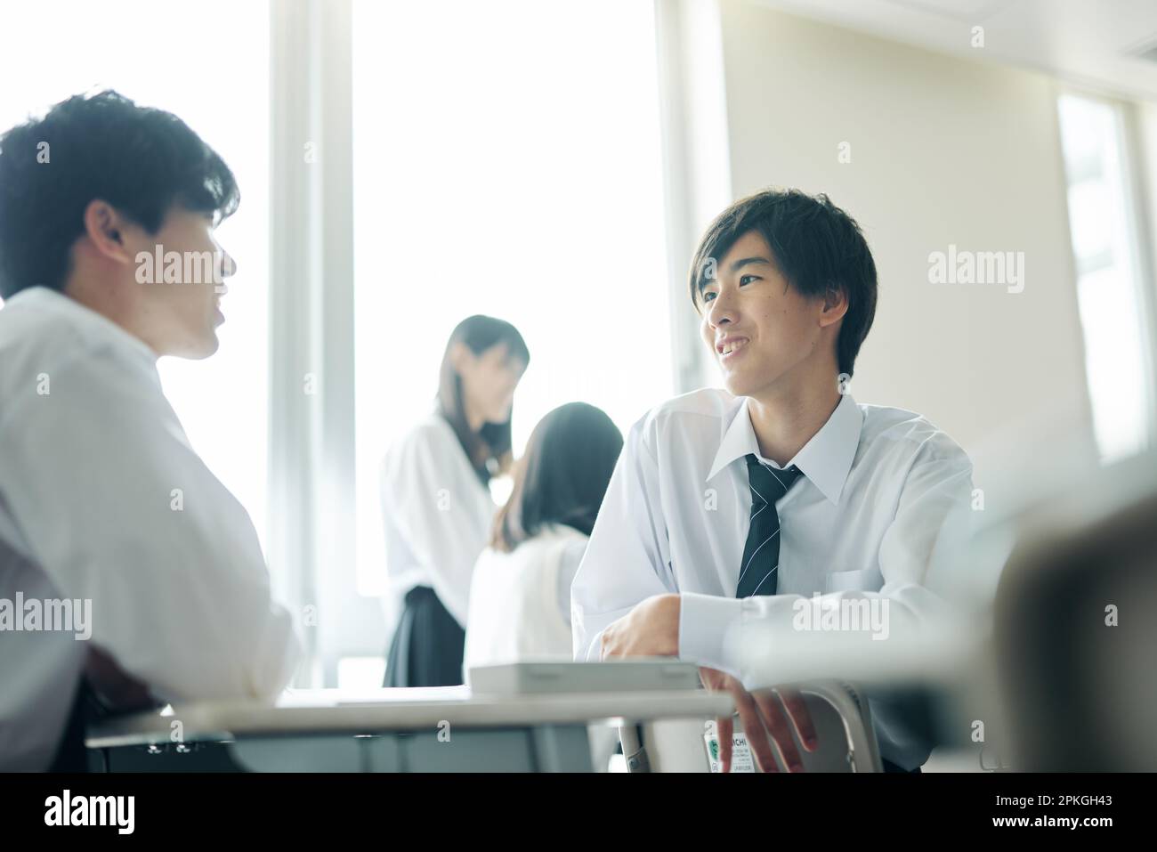 High school boys chatting in a classroom Stock Photo - Alamy