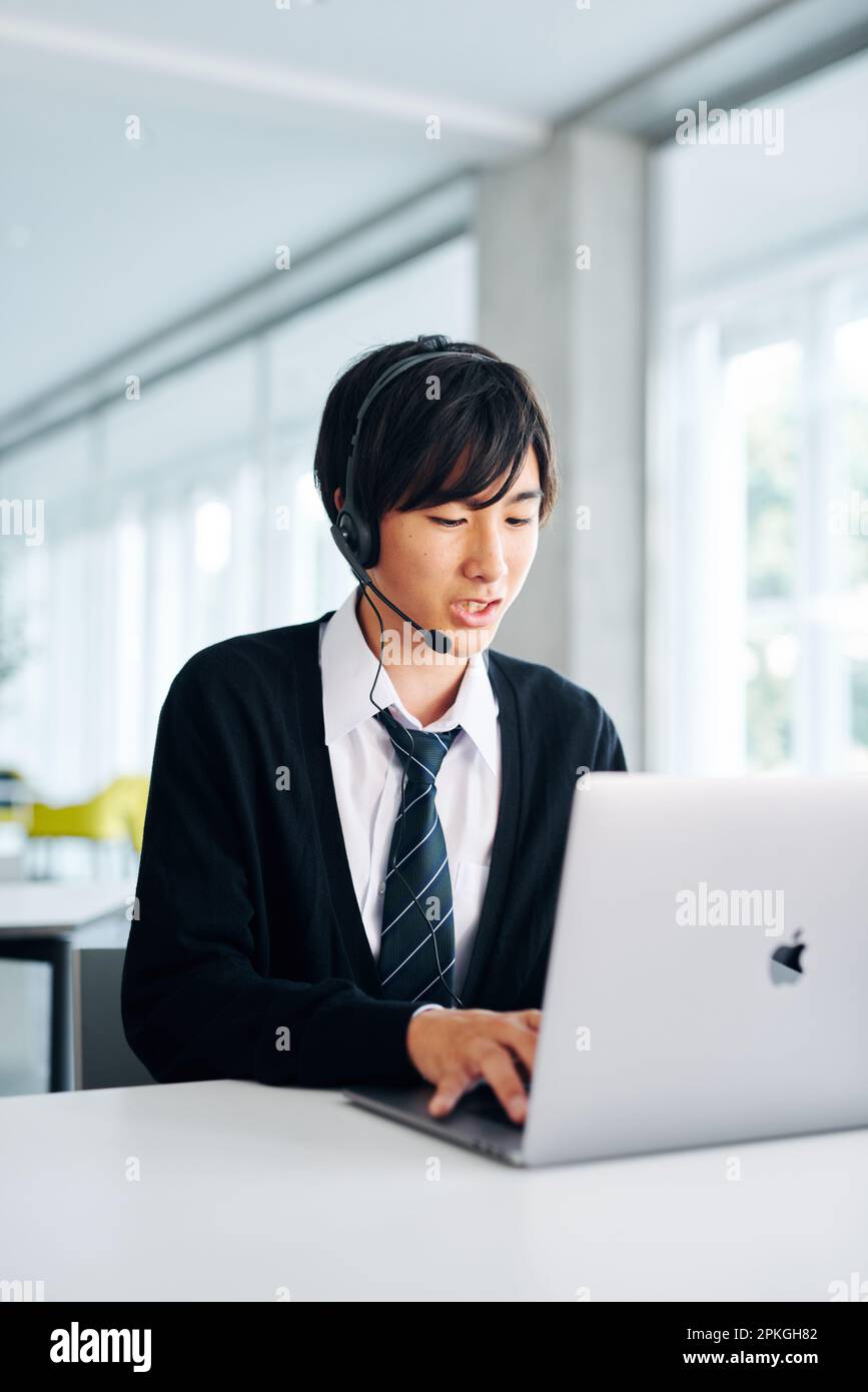 A high school boy taking an online class at a cram school Stock Photo ...