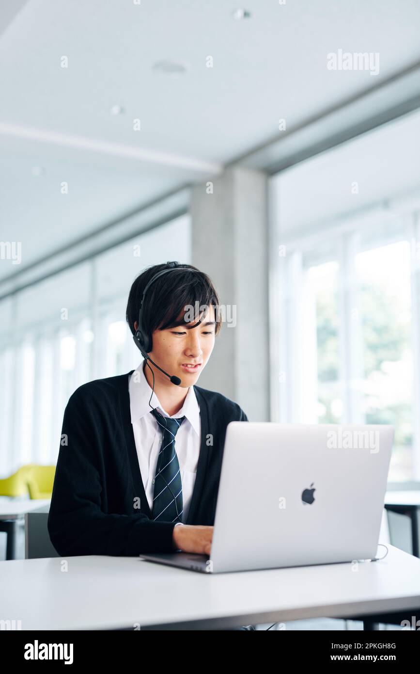 A high school boy taking an online class at a cram school Stock Photo ...
