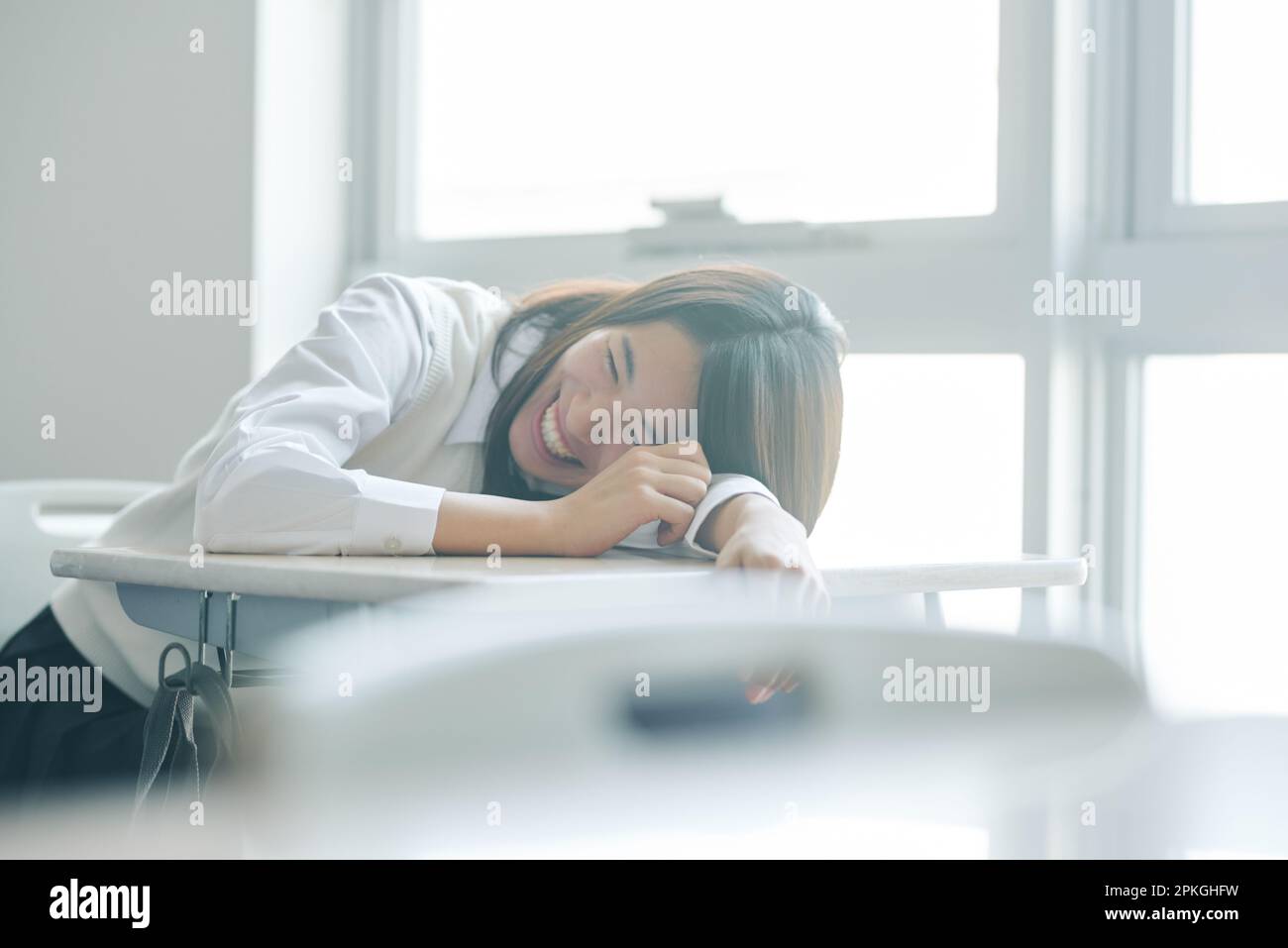 High school girls smiling in a classroom Stock Photo - Alamy
