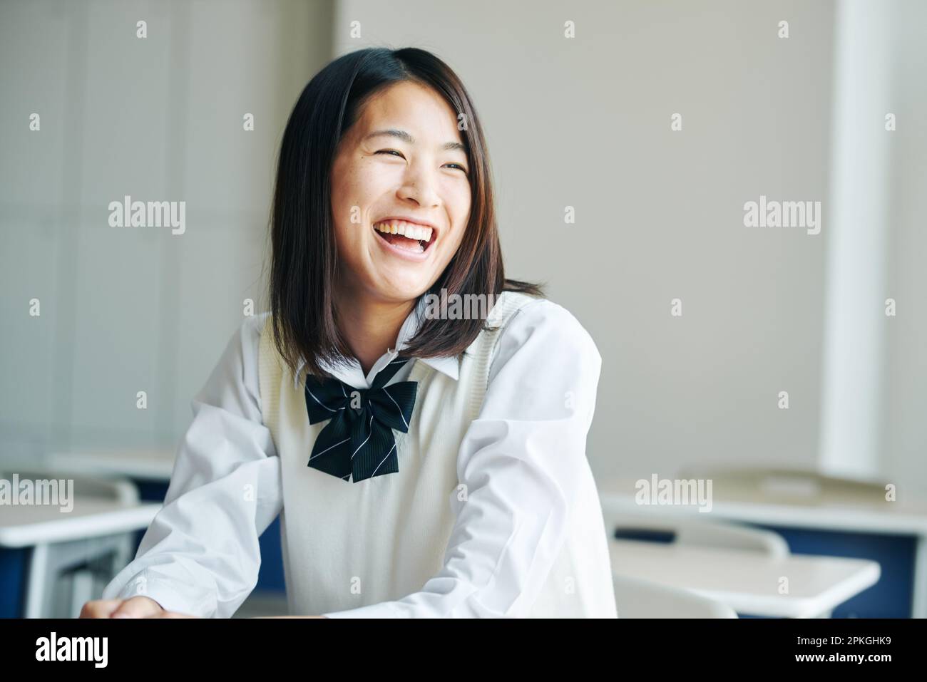 Smiling high school girls in a classroom Stock Photo - Alamy