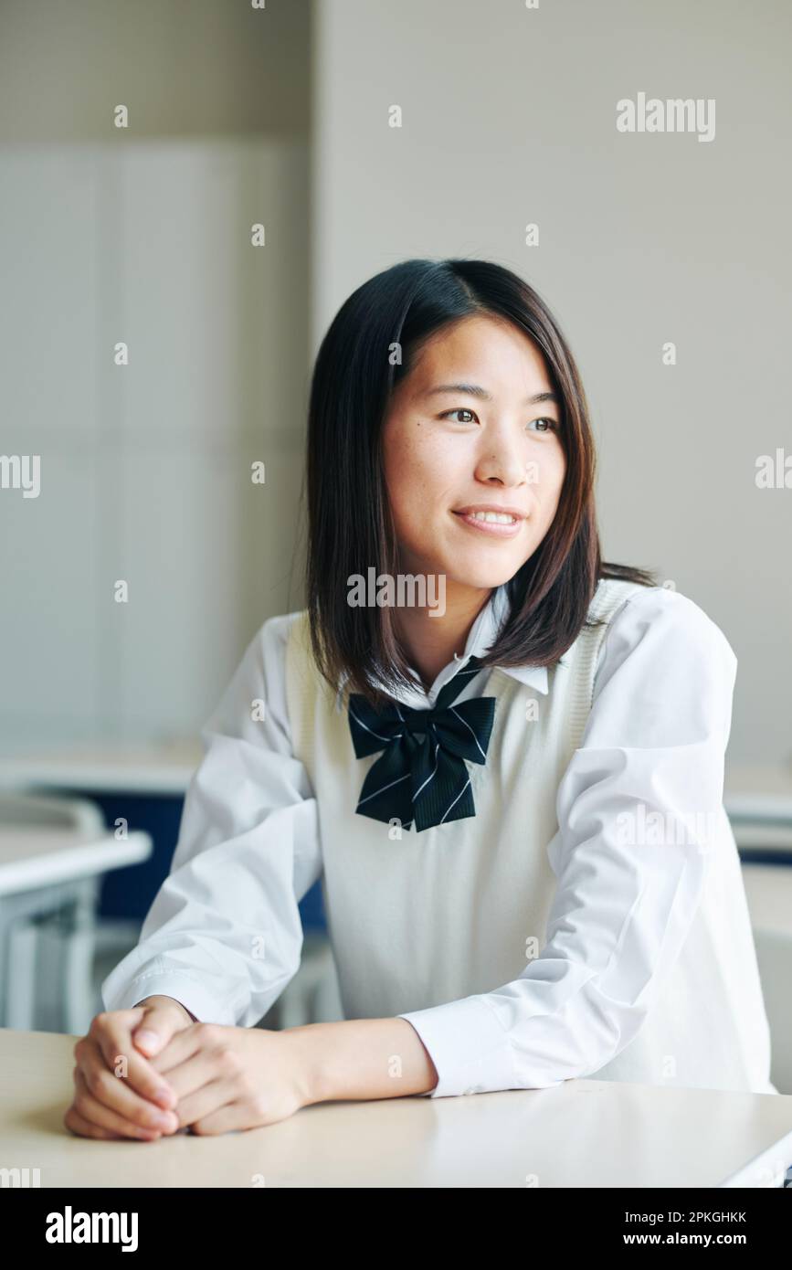 High school girls smiling in a classroom Stock Photo - Alamy