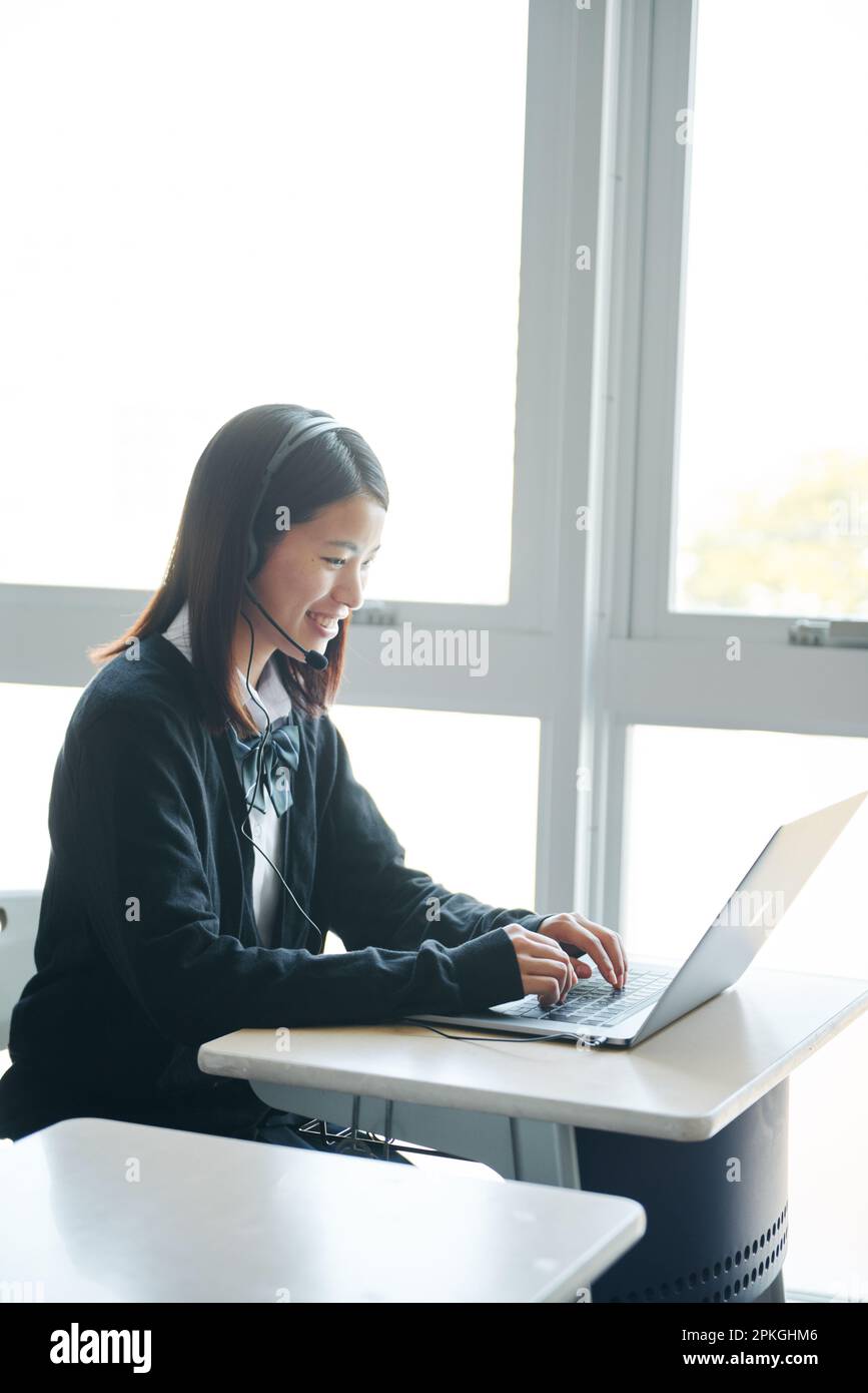 High school girls operating a computer in a classroom Stock Photo - Alamy